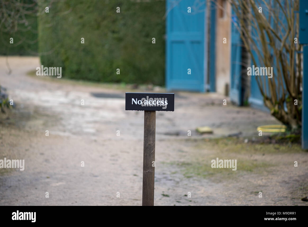 isolated no access sign in english country garden with rain droplets ...