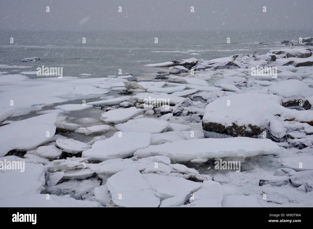 Layers of snow on fractured ice, Lofoten, Norway Stock Photo - Alamy