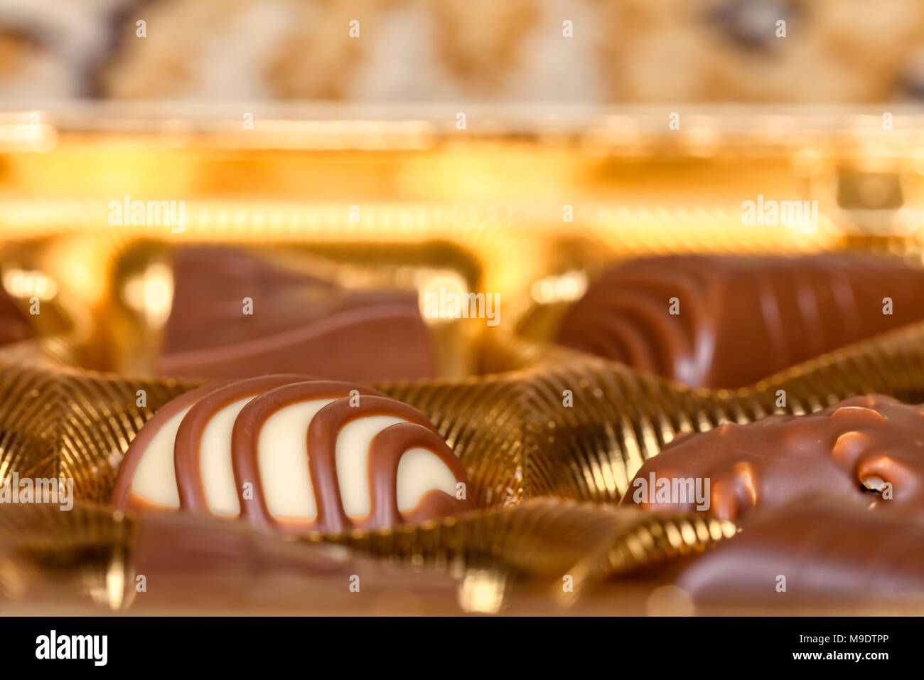 A box of chocolates with the golden colored case in the shop window ...