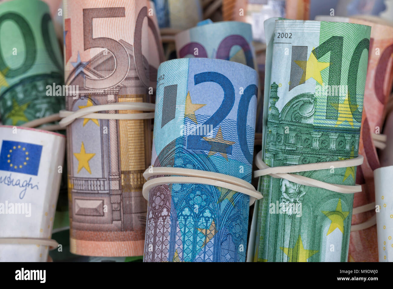 Many euro bills of different values and rolled with a rubber band Stock ...