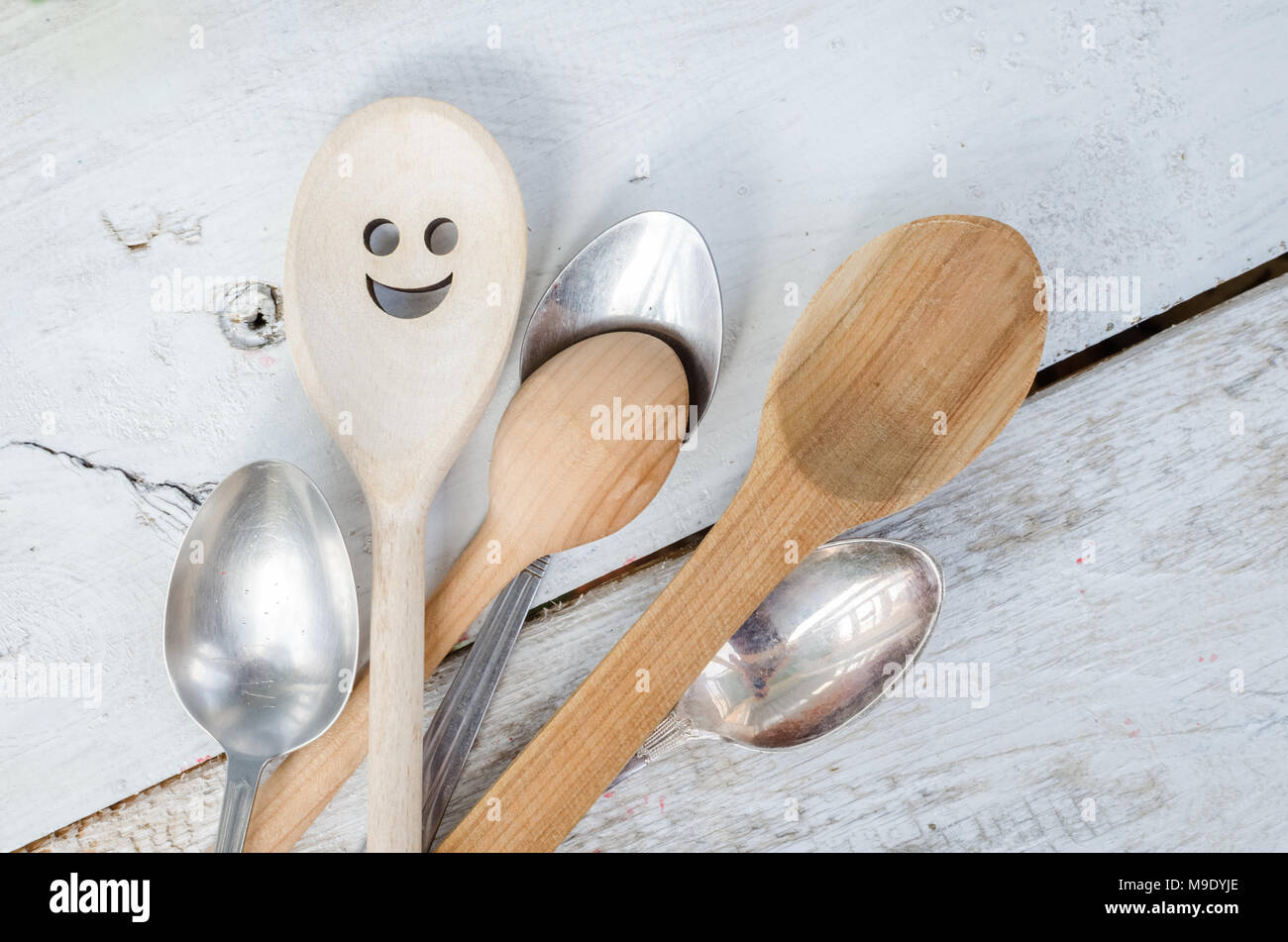 One spoon with smiley face standing with the crowd - individuality ...