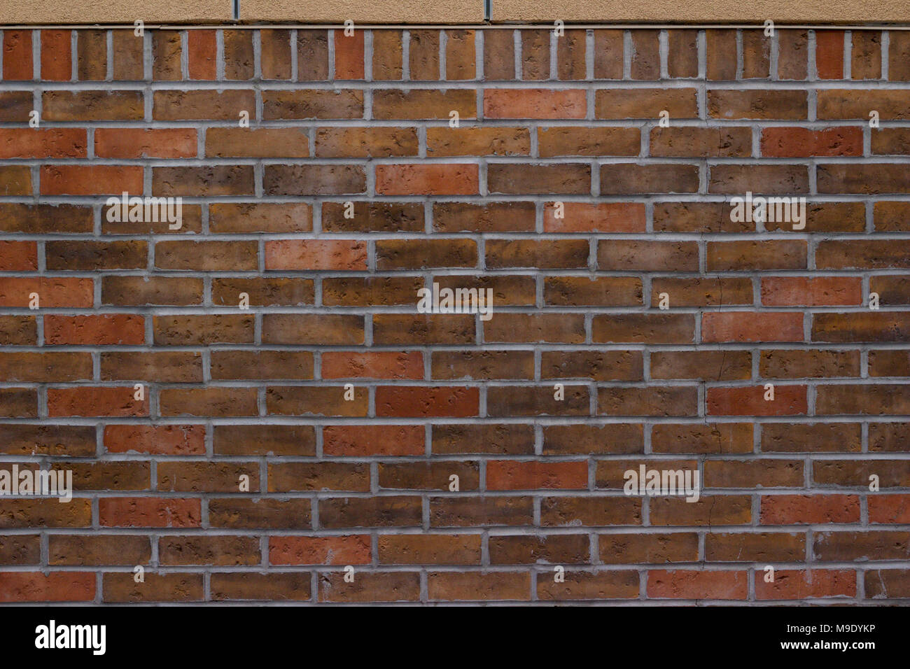 Brick wall background with bricks in varying colors of red and brown in ...