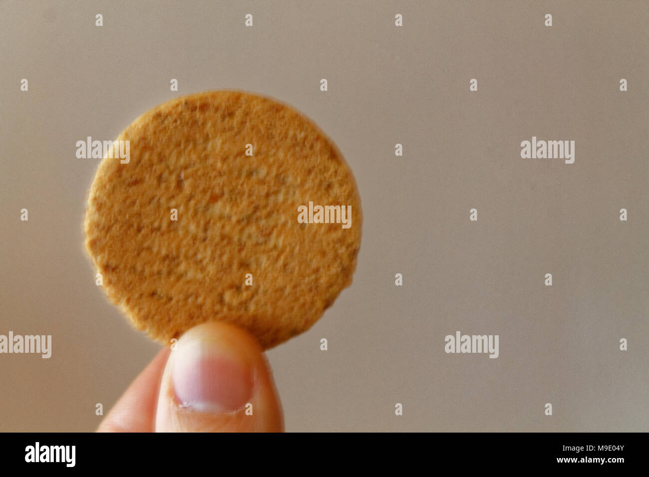 Wholegrain biscuits in hand Stock Photo - Alamy