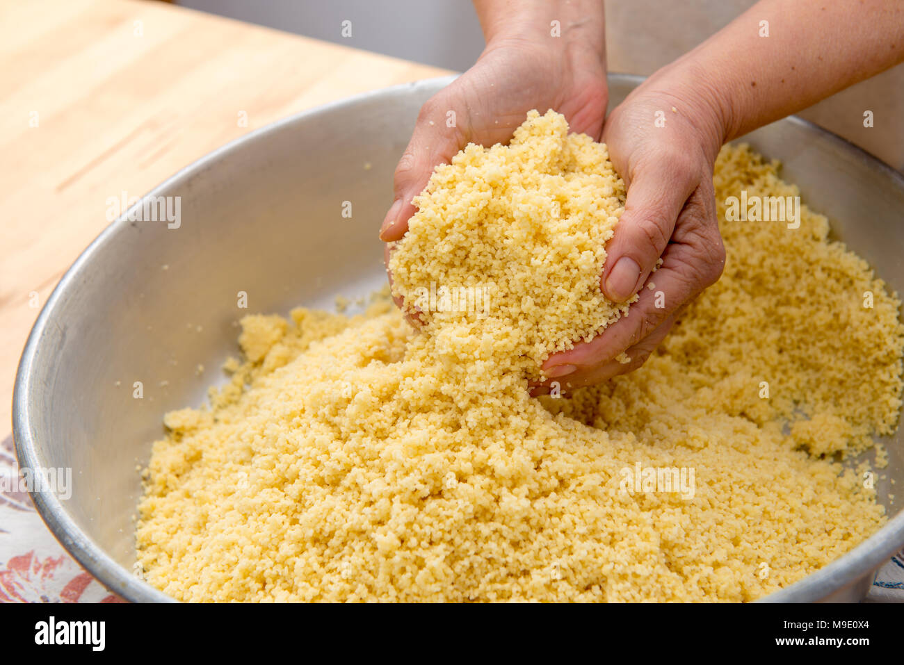semolina preparation for delicious couscous Stock Photo - Alamy