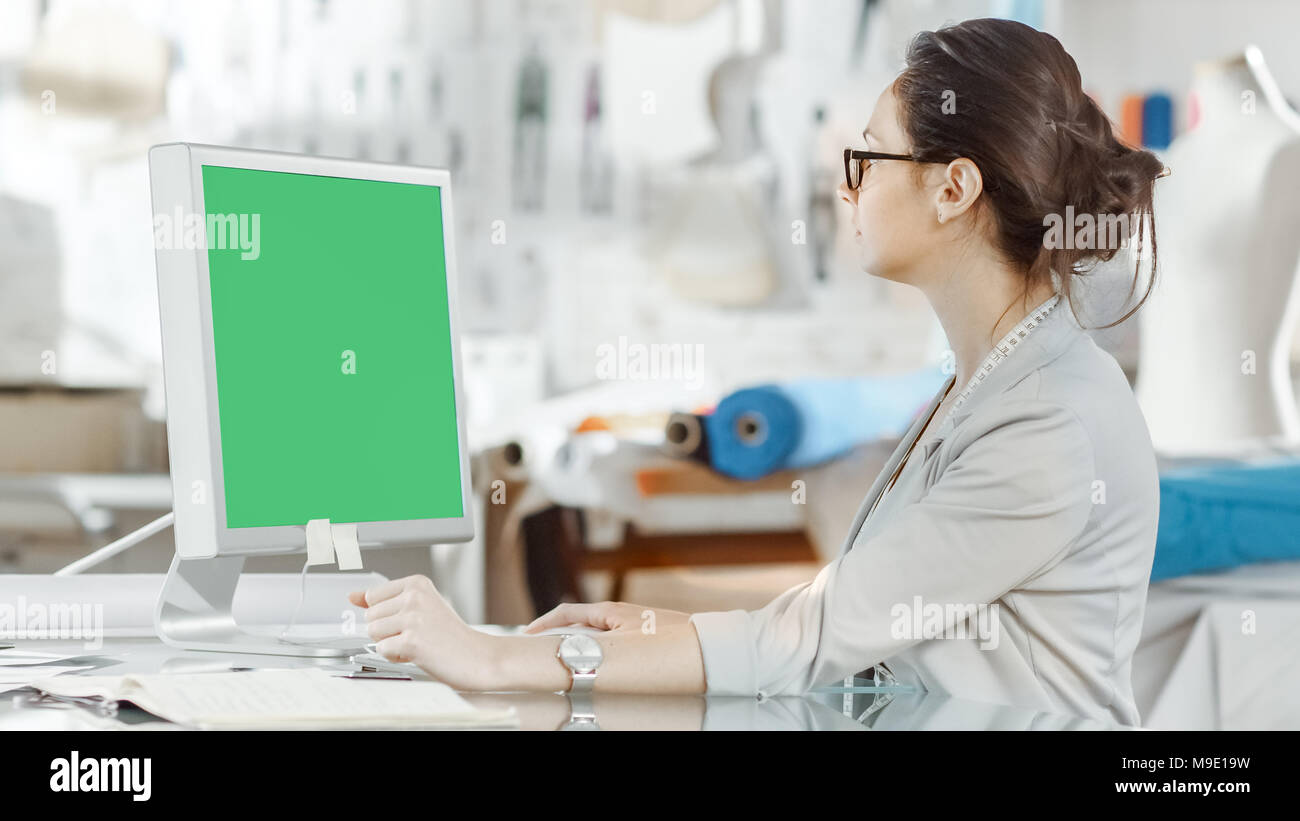 Beautiful fashion, designer, Sits at Her Desk before Personal Computer ...