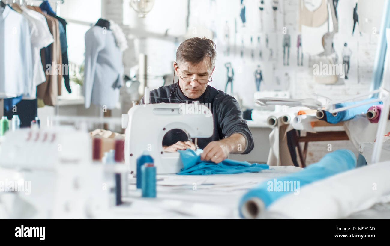 Male fashion, designer, / Dressmaker Working on a Sewing Machine in His ...