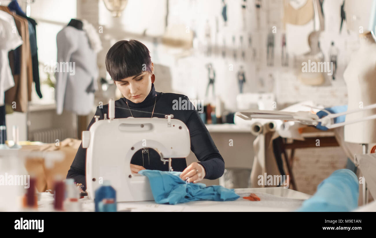 A young seamstress working on the mannequin hi-res stock photography ...