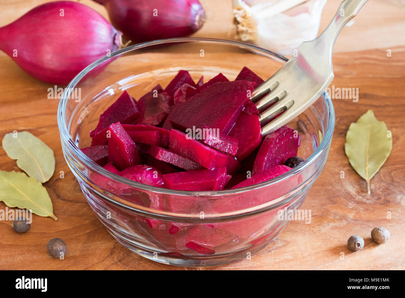 Fermented red beet in a bowl, with onions, garlic, allspice and bay ...