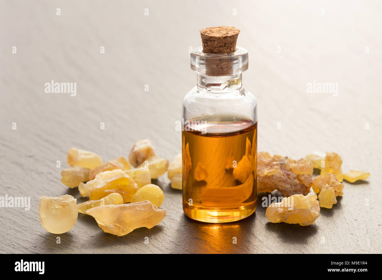 A bottle of frankincense essential oil with frankincense resin on a ...