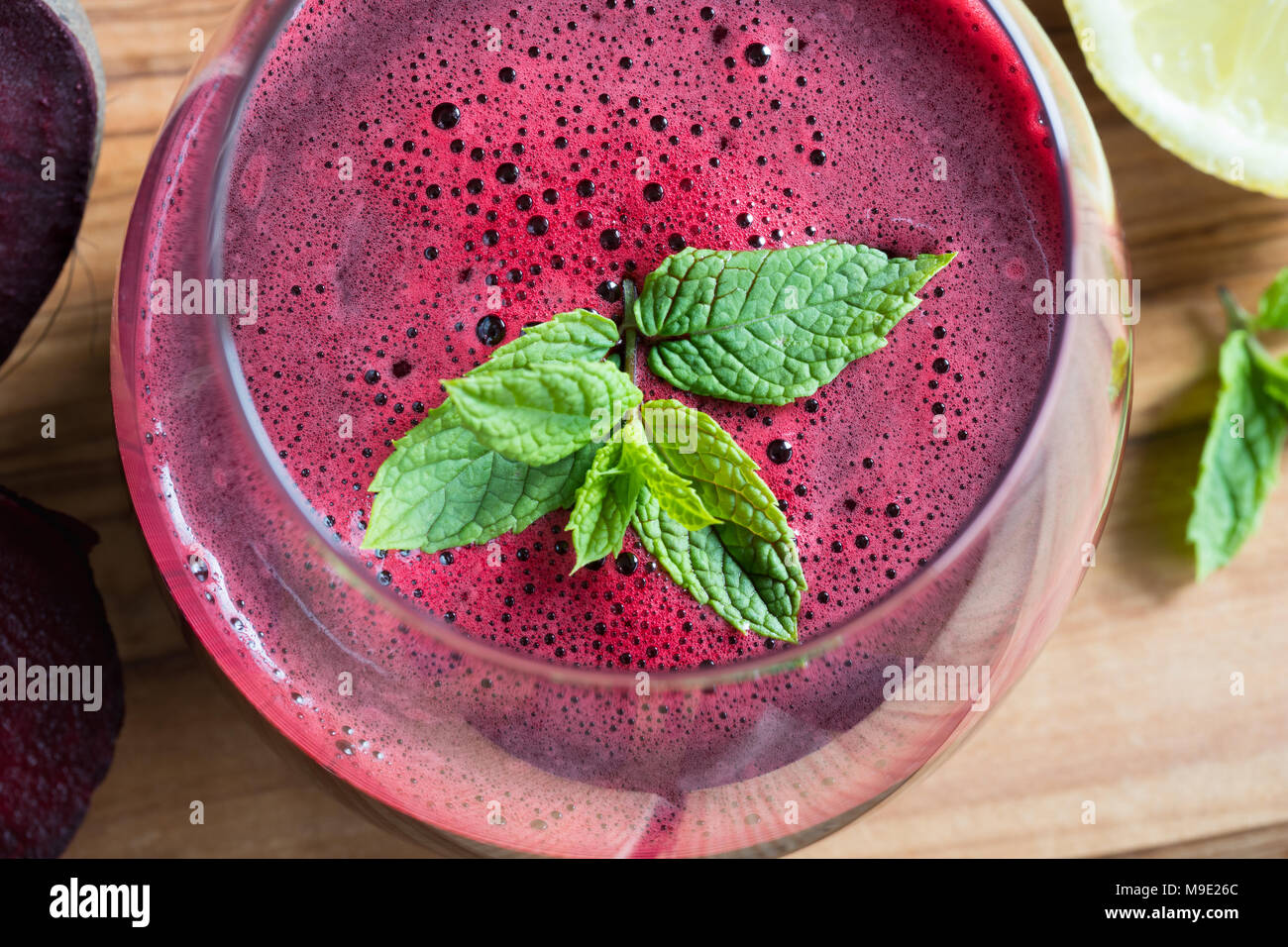 Red beet juice in a glass with fresh mint leaves, top view Stock Photo ...
