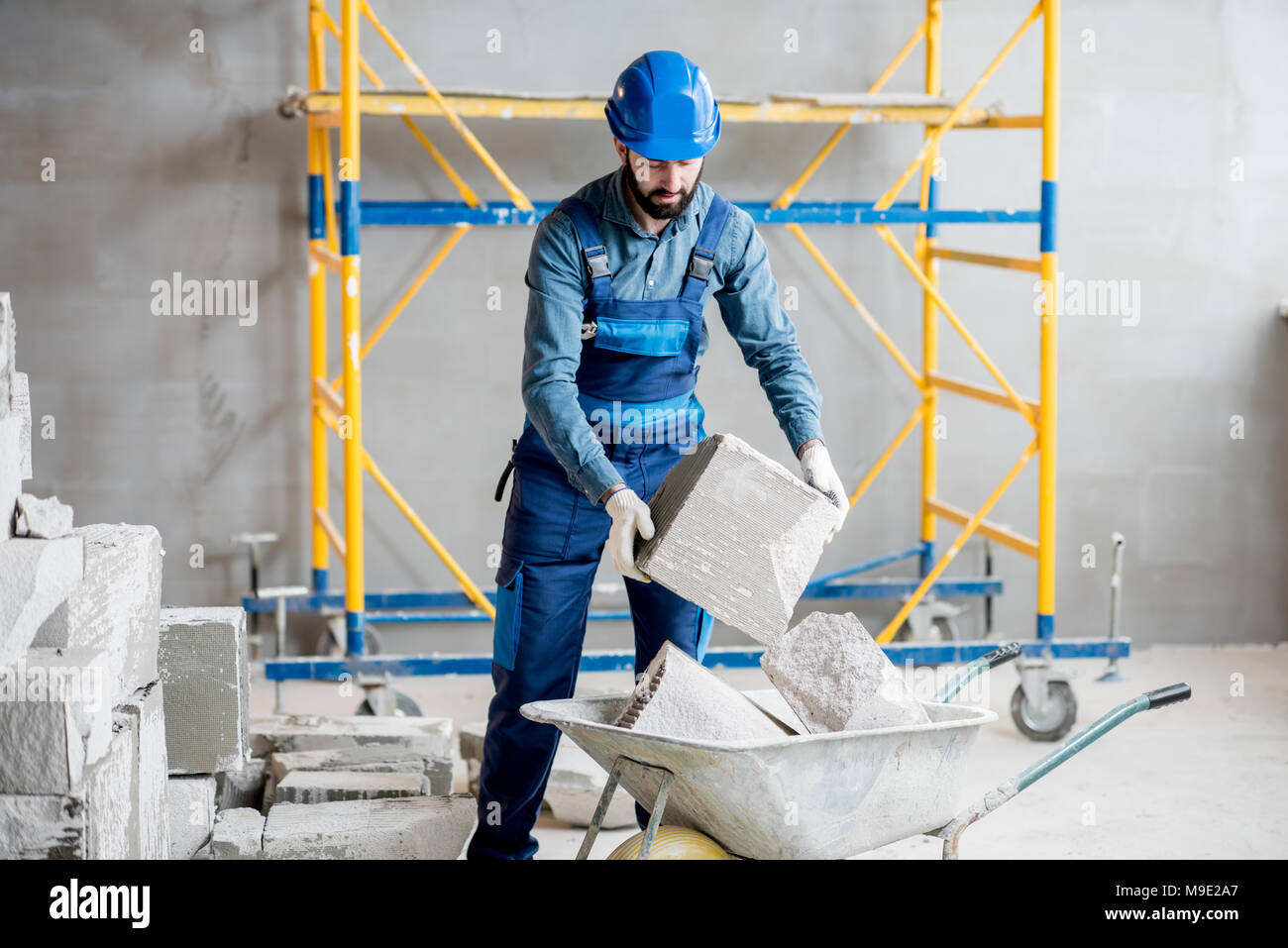 Builder working with blocks indoors Stock Photo - Alamy