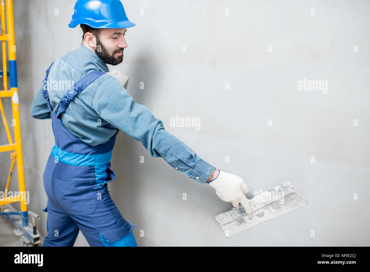Plasterer working indoors Stock Photo - Alamy