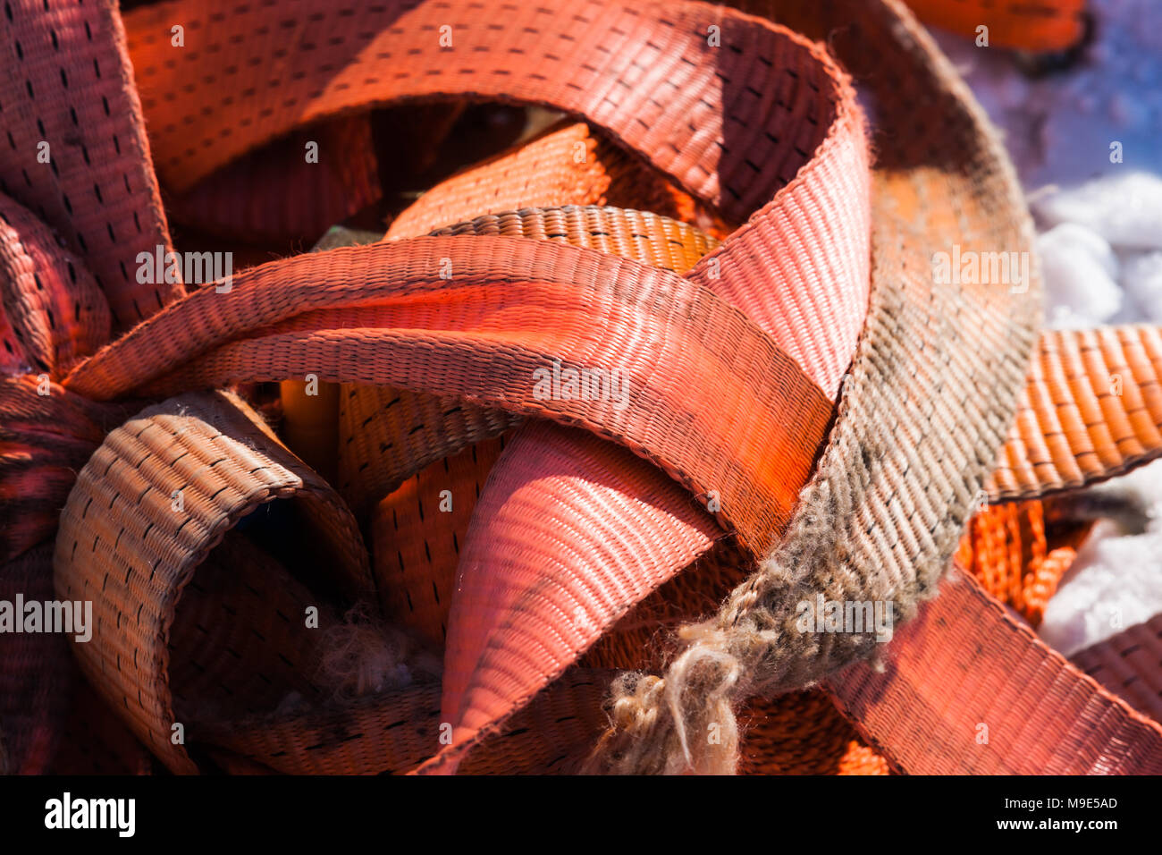 Bunch of orange plastic construction tape in snow. Decorative pattern ...
