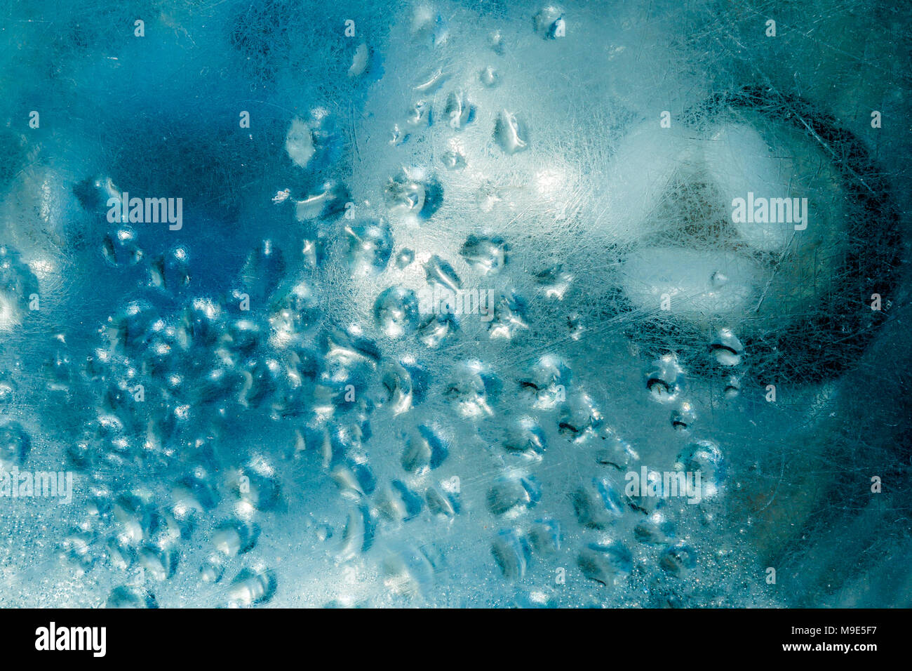 Texture of thick glass of a blue color, grunge, heavily scratched with ...