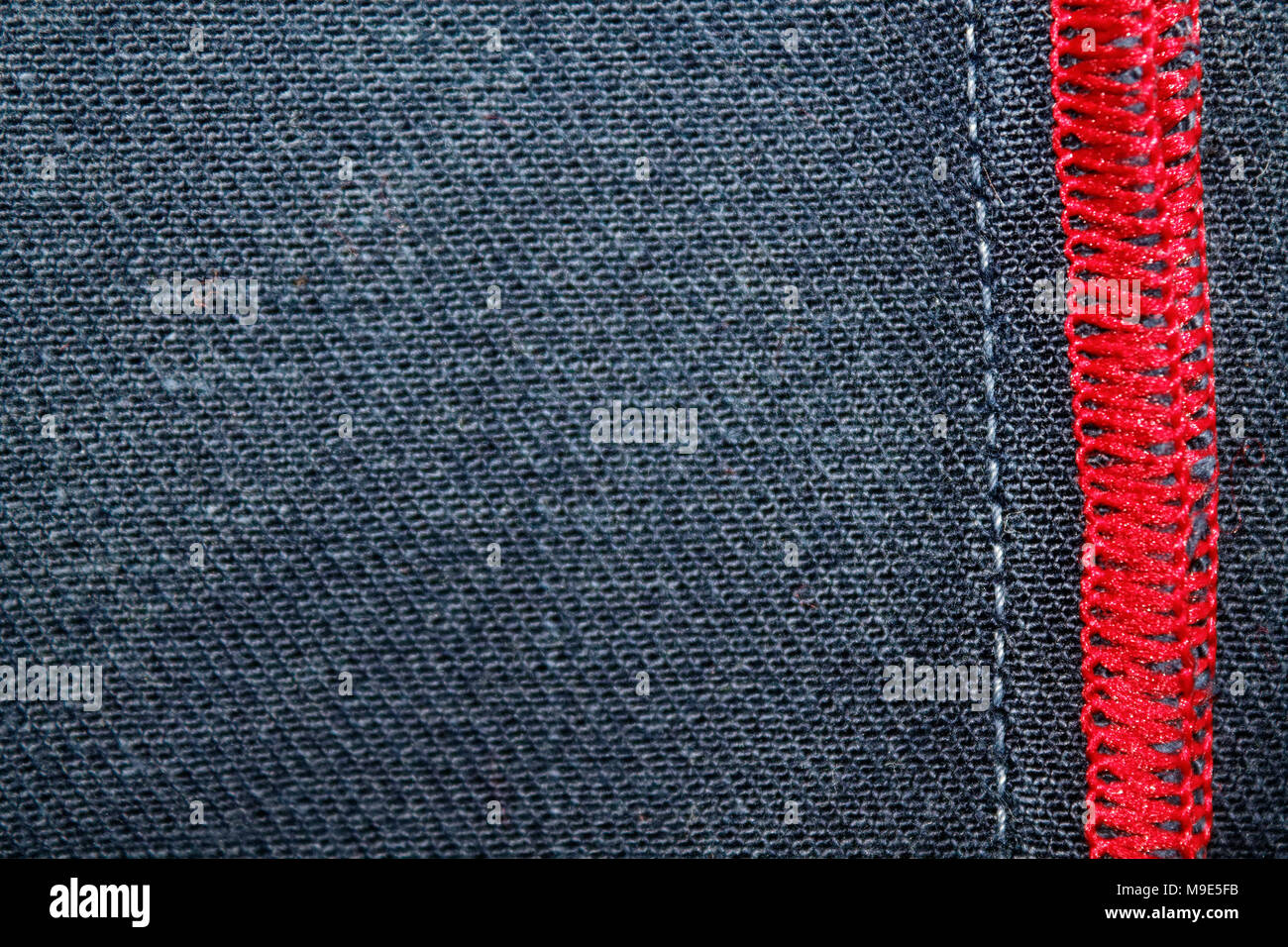 Denim texture with red seam for jeans background Stock Photo - Alamy