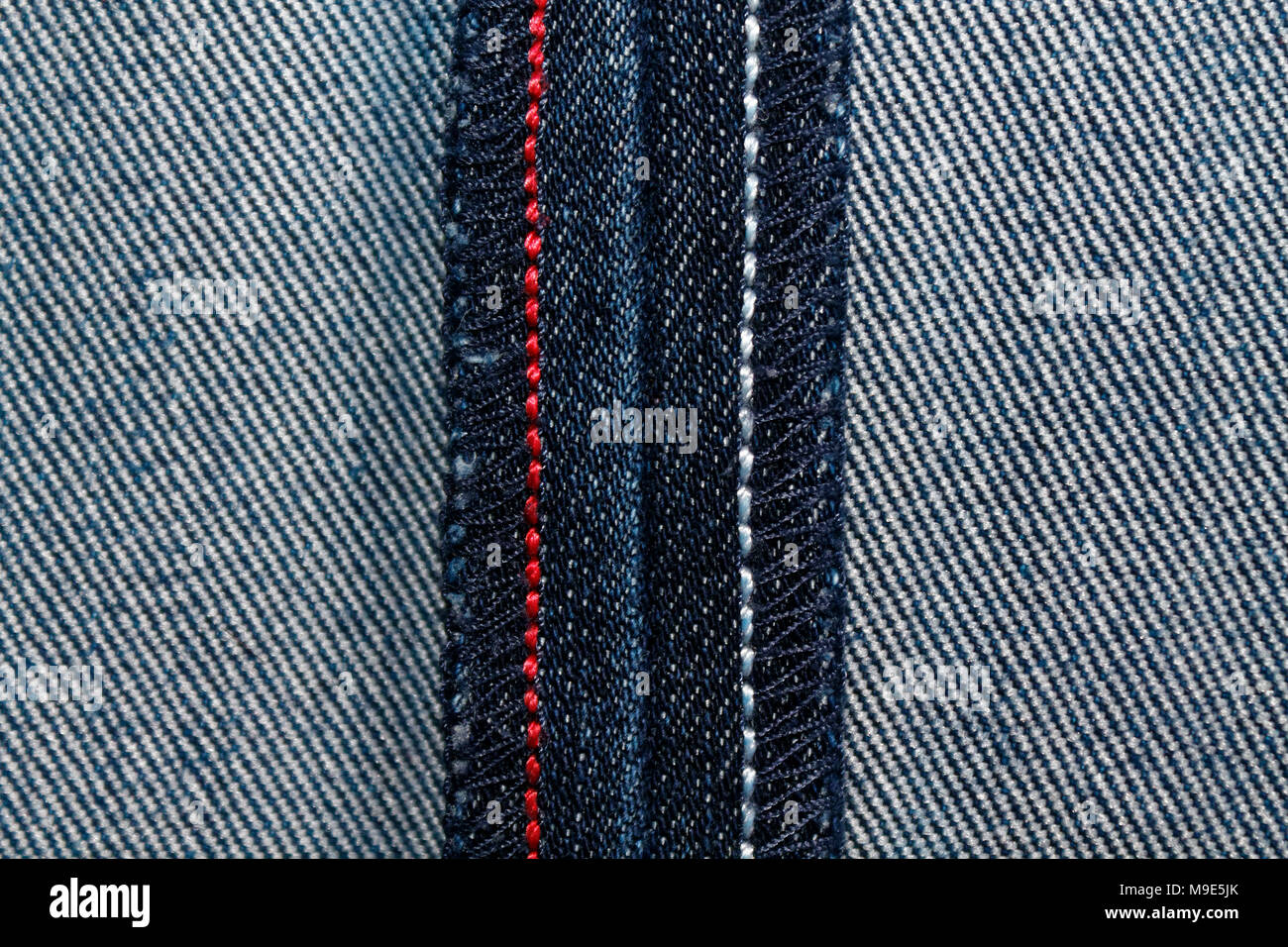 Denim texture with red seam for jeans background Stock Photo - Alamy