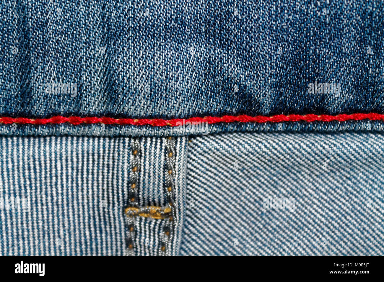 Denim texture with red seam for jeans background Stock Photo - Alamy