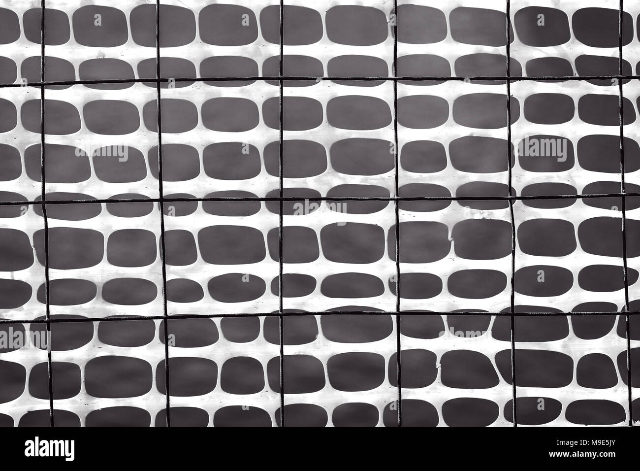 Dark wire grid and plastic protective mesh of an white color against ...