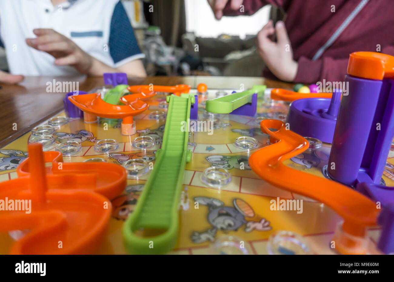 Two boys playing a family board game of Snakes and Ladders Stock Photo ...