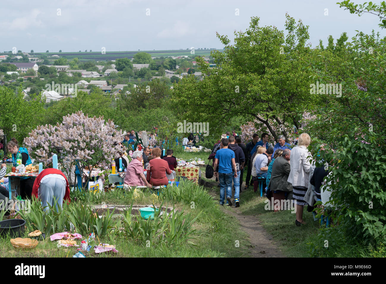 TOCUZ, MOLDOVA- 9 MAY, 2016: People in the cemetery celebrating the ...