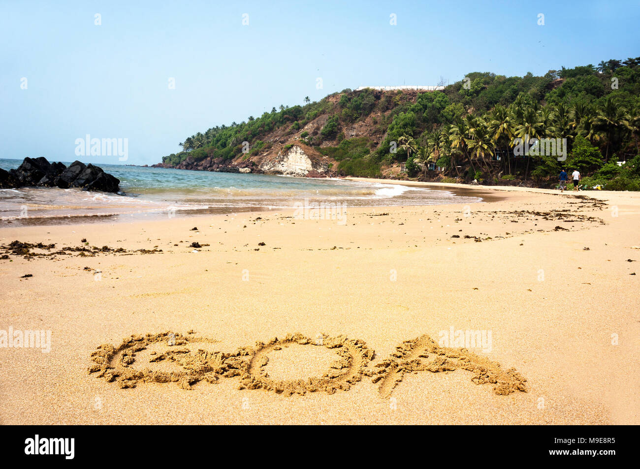 The inscription of Goa on the sand on the beach against the blue sea ...
