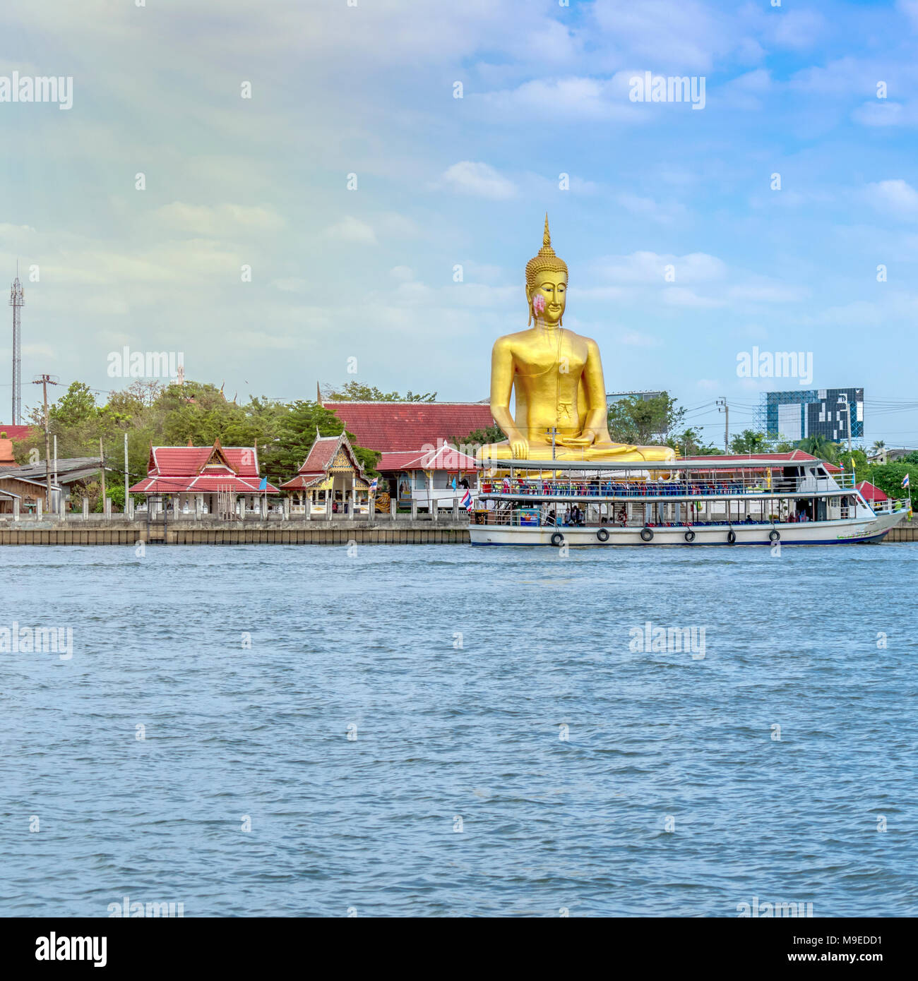 Golden Color Buddha statue in front of the temple along the Chao Phraya ...