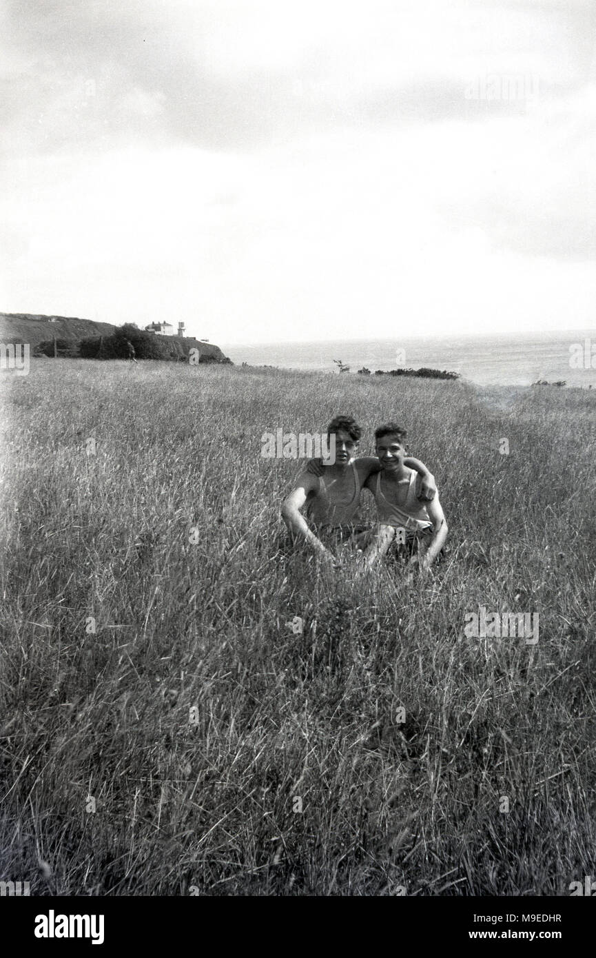 1930s, historical, two British boy scouts on an overseas trip, sitting ...