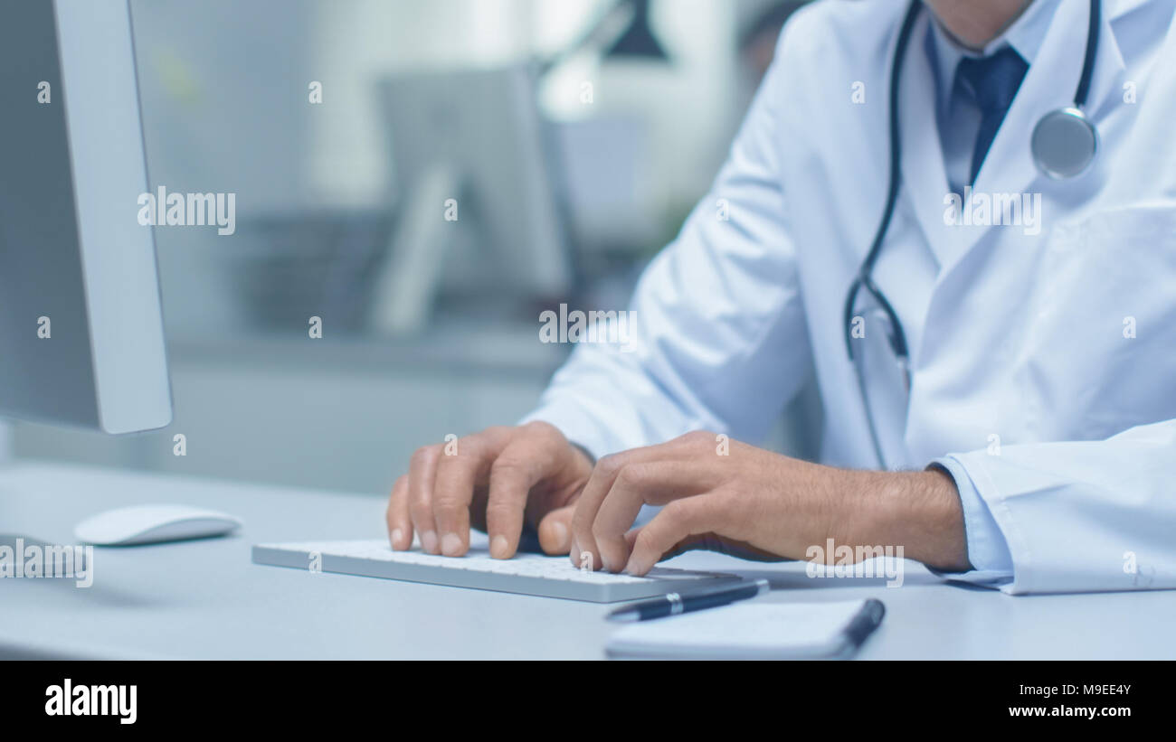 Close-up shot of Senior Doctors Hands Using Keyboard Typing a Message ...