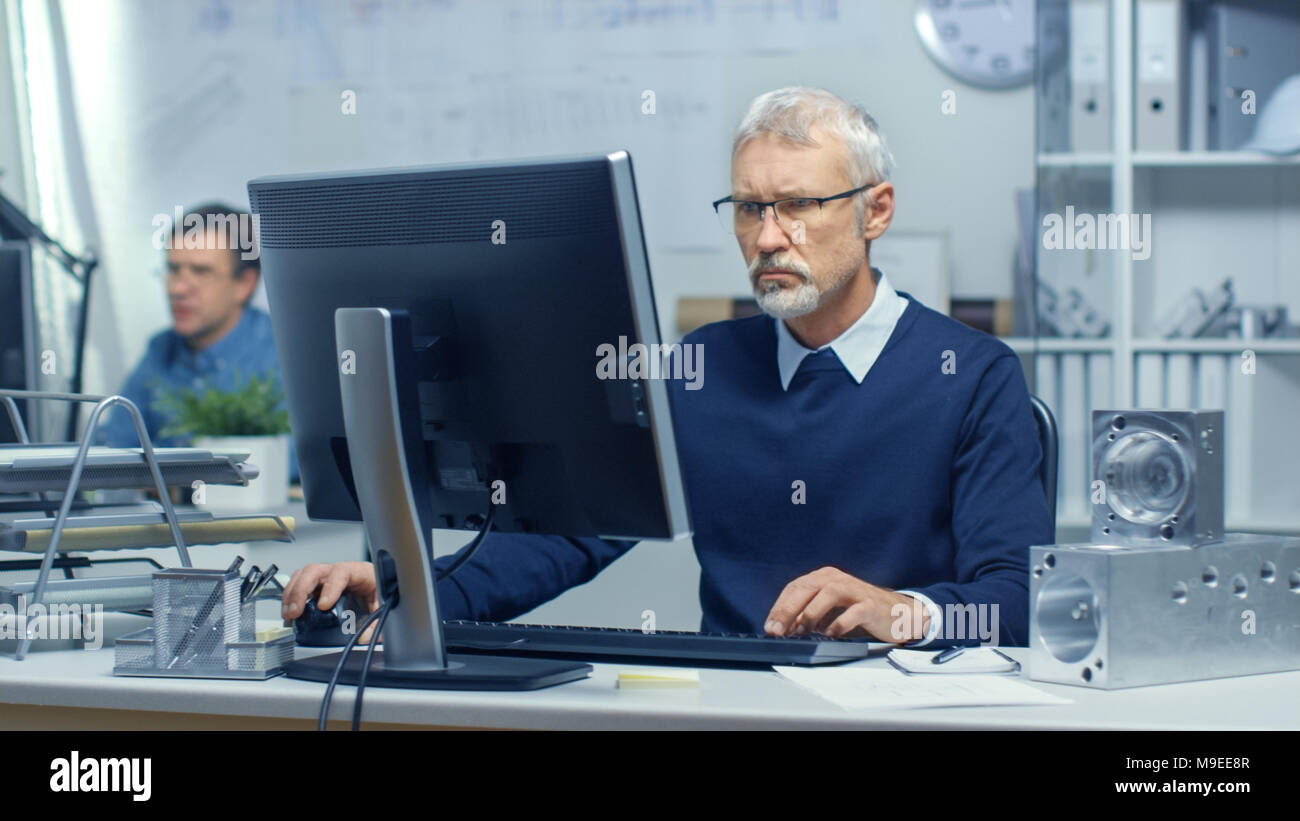 Busy Engineer Bureau. Chief Engineer Working at His Computer, Some ...
