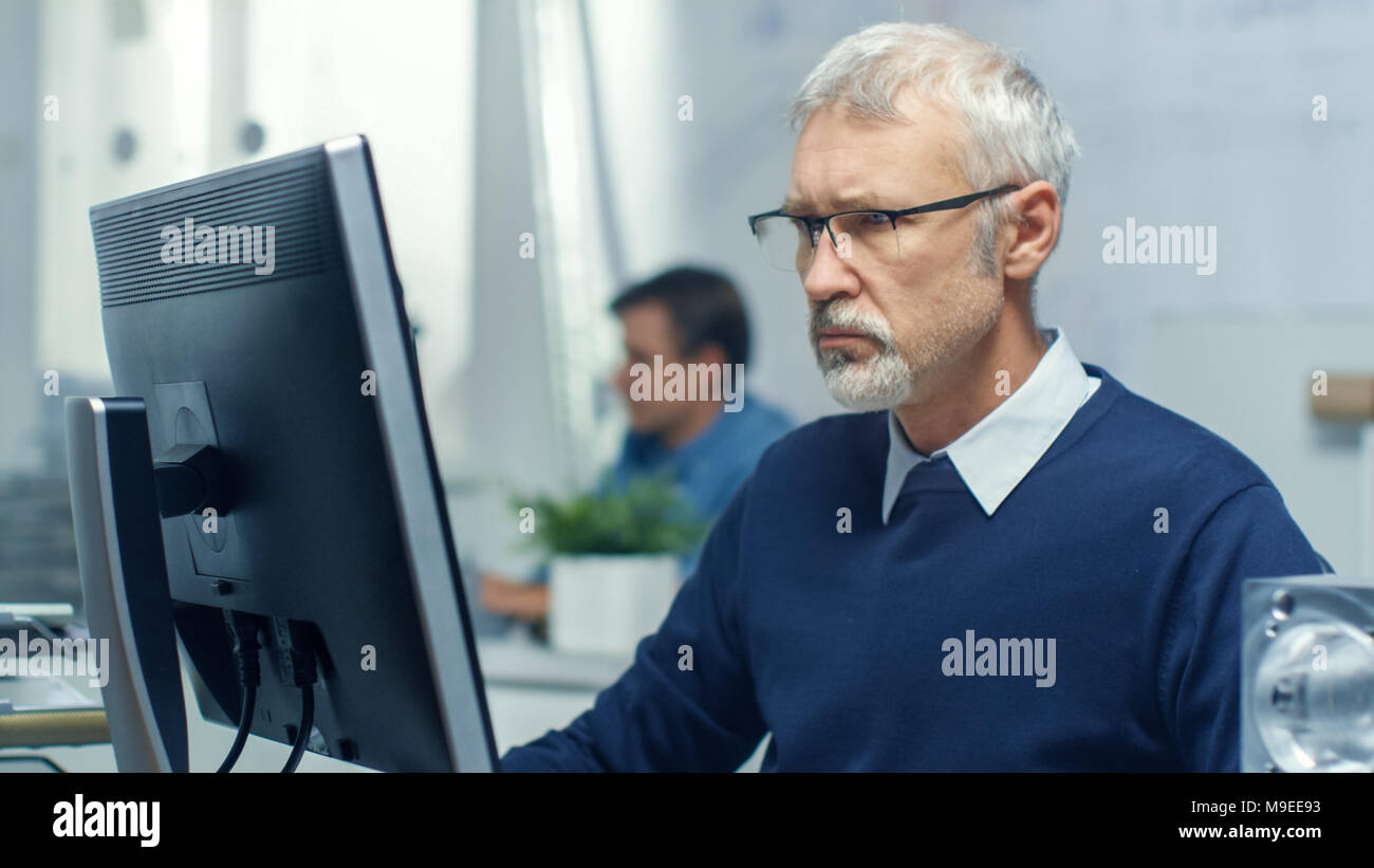 Engineering Bureau. Chief Engineer Working at His Desk, Some Technical ...