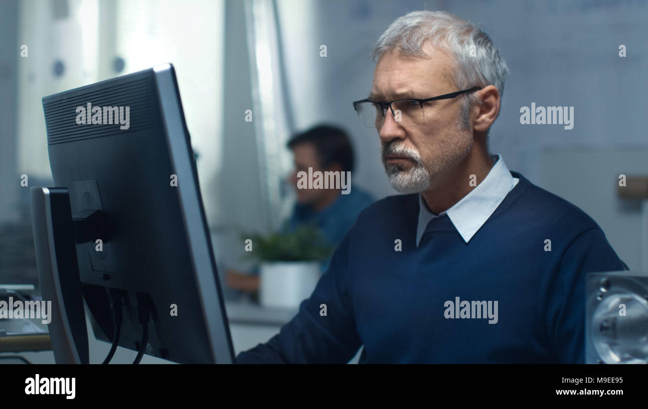 Engineering Bureau. Chief Engineer Working at His Desk at night, Some ...