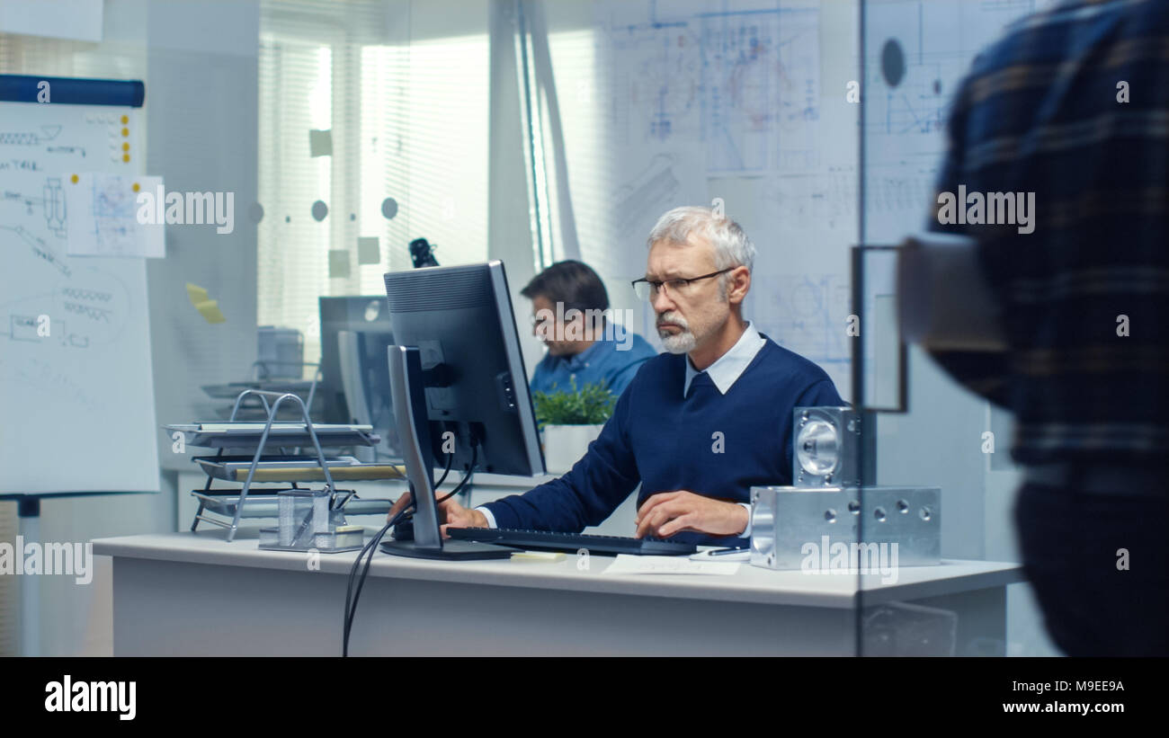 Busy Engineering Bureau. Engineer Working at His Desk, Some Technical ...