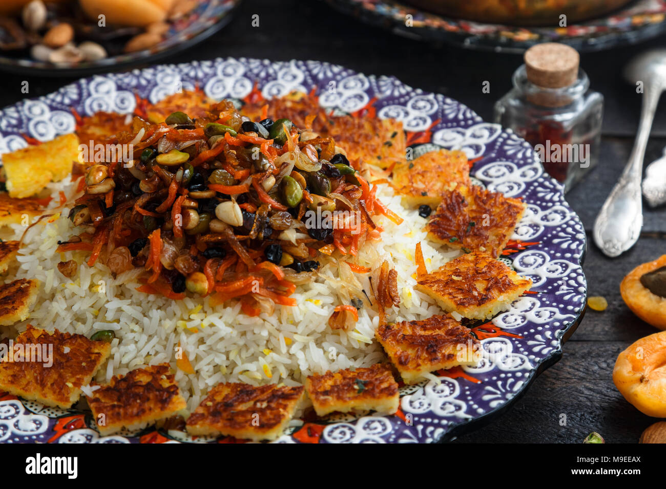 Iranian wedding pilaf topped with nuts, orange zest and raisins, rustic ...