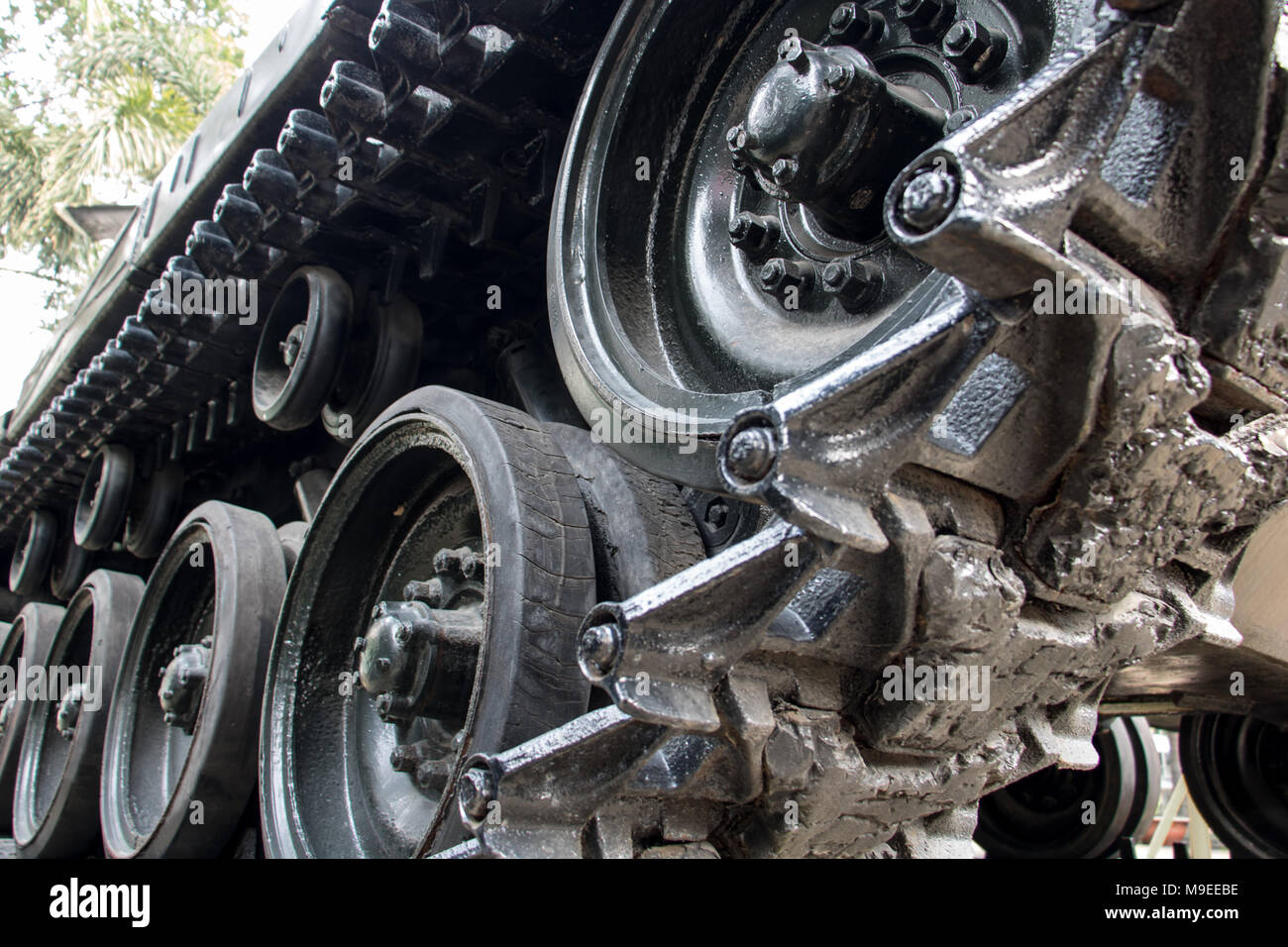 A closeup of tracks of an old tank. The part of tank with a large ...