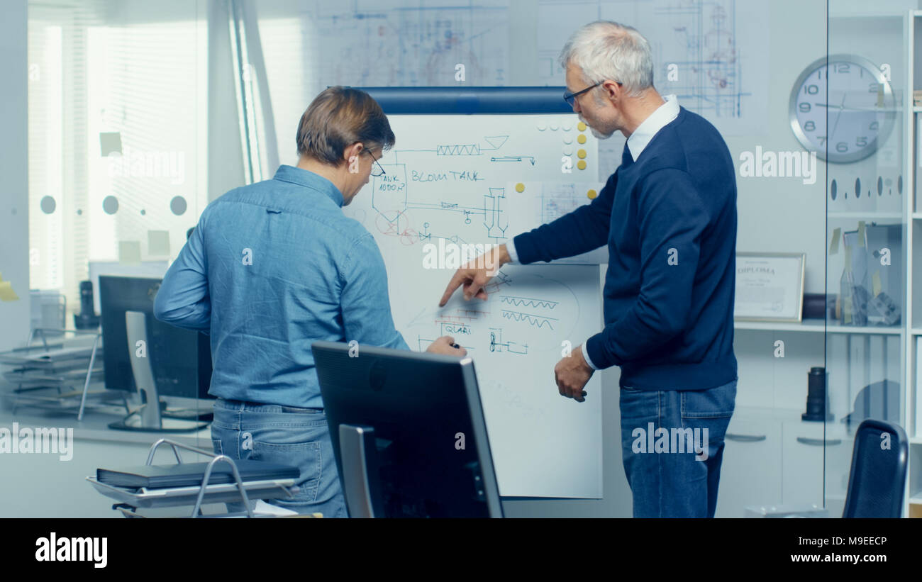 In Architectural Engineering Office Two Senior Engineers Working with ...