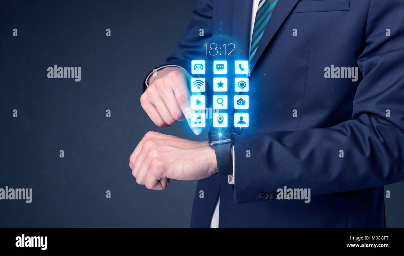 Businessman wearing smartwatch with application icons Stock Photo - Alamy