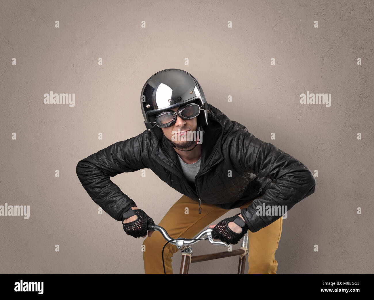 Nerd young foolish biker on a bike with oldschool outfit Stock Photo ...