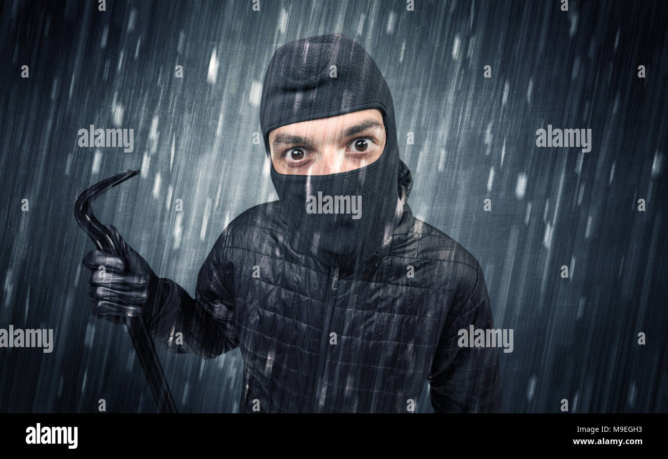 Burglar in action in black clothes with rainy concept Stock Photo - Alamy