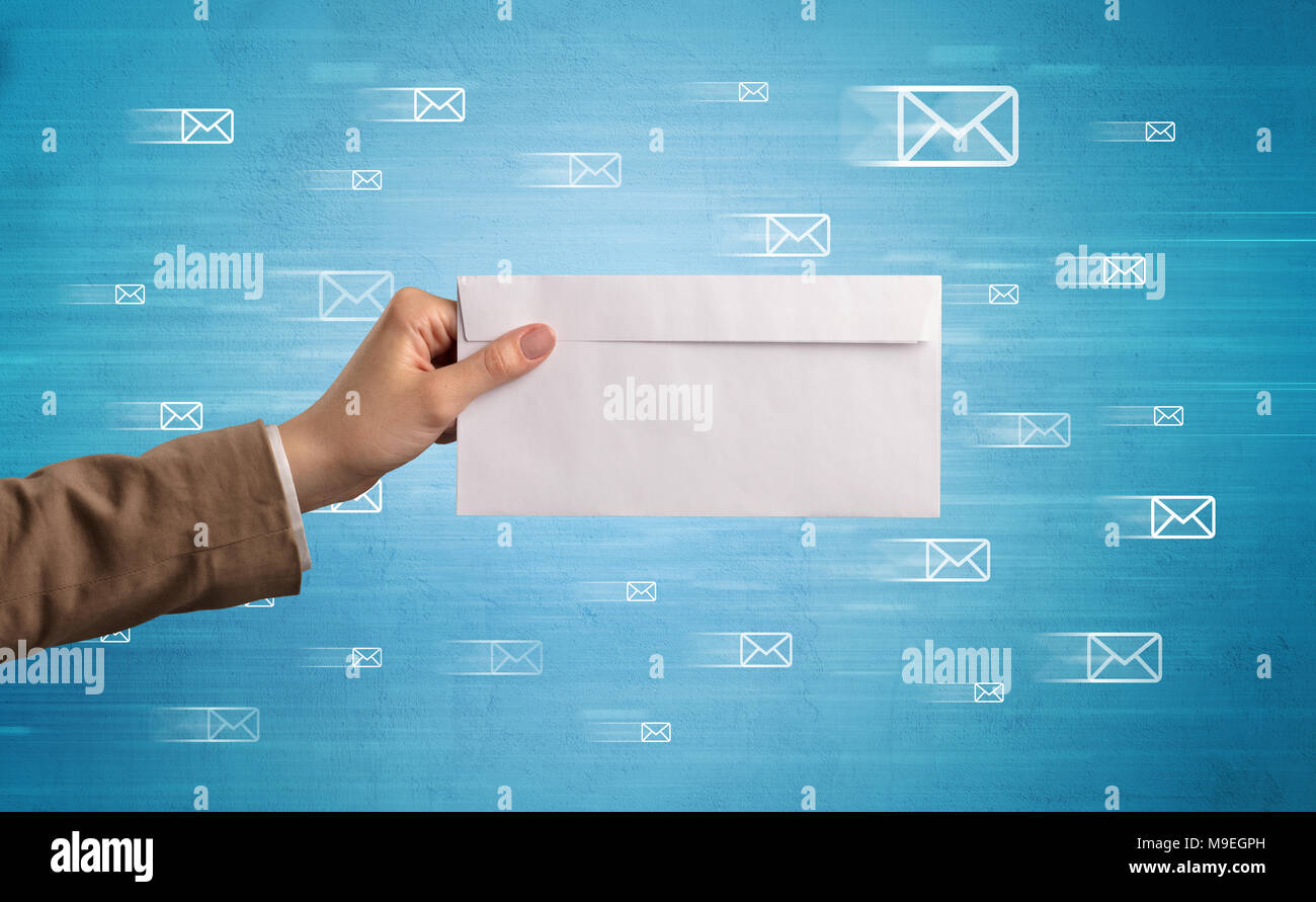 Female hand holding coloured and white envelope with blue background ...