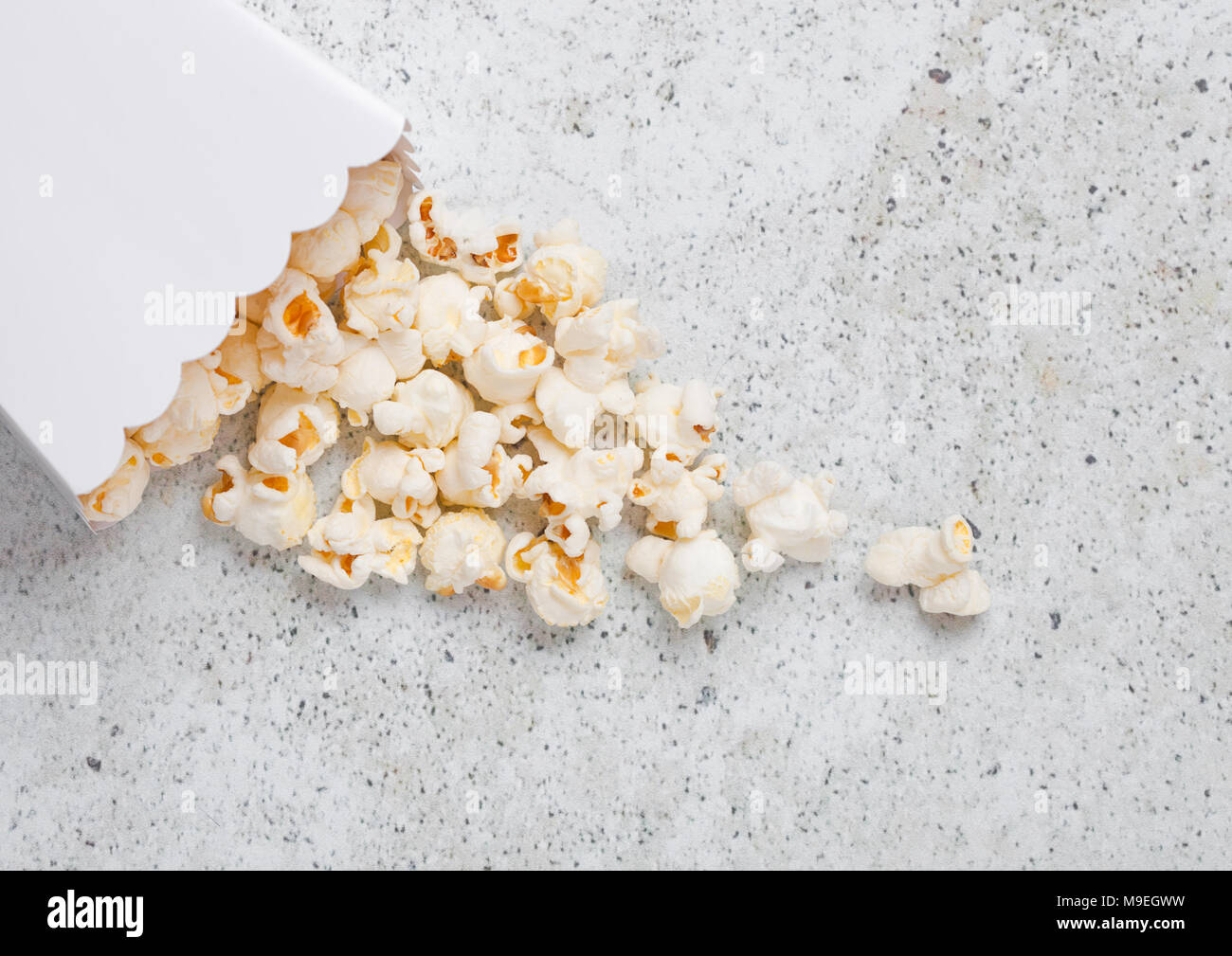 Paper container with fresh salted popcorn on stone background Stock ...