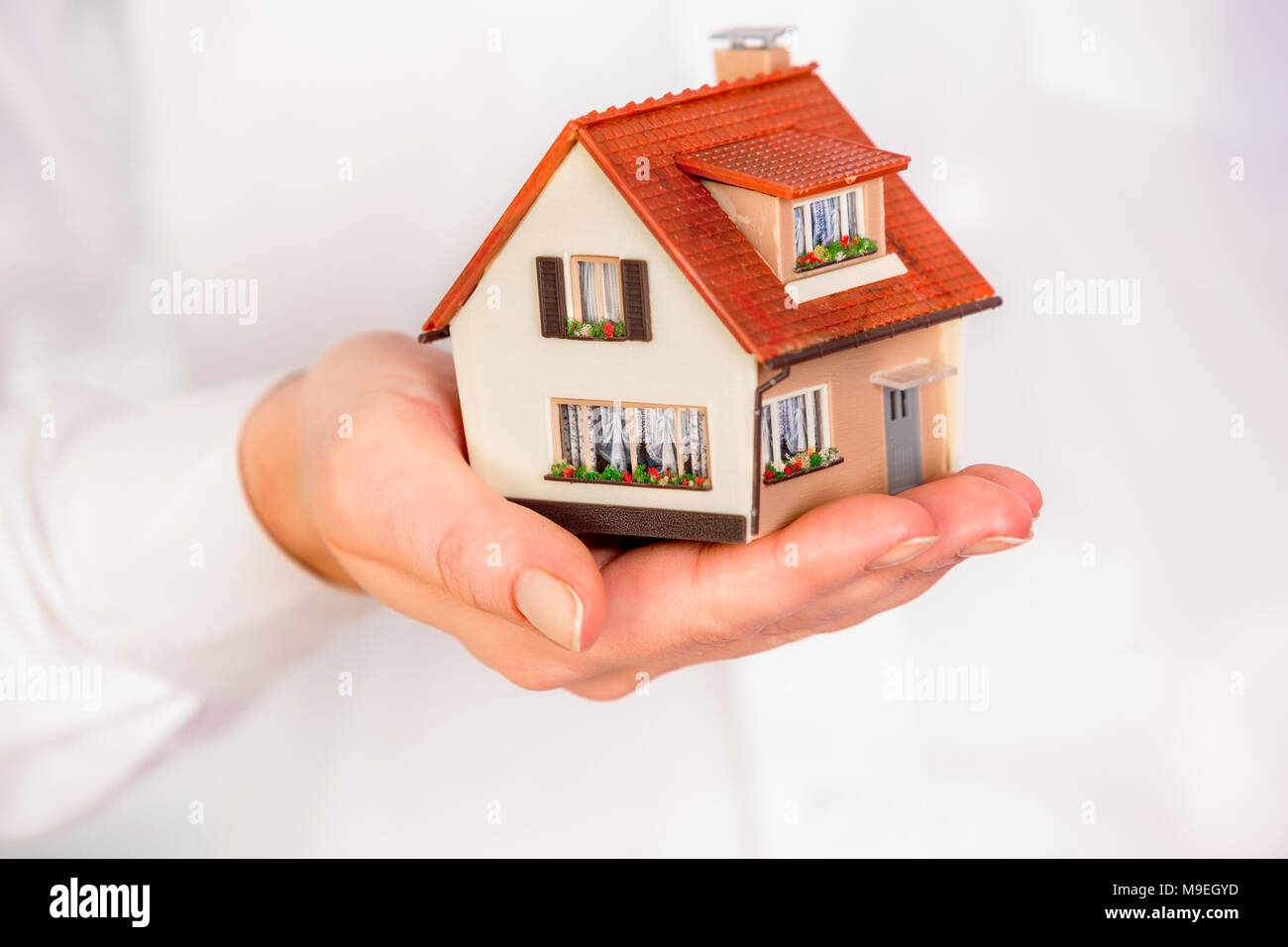 House in human hands on a white background Stock Photo - Alamy