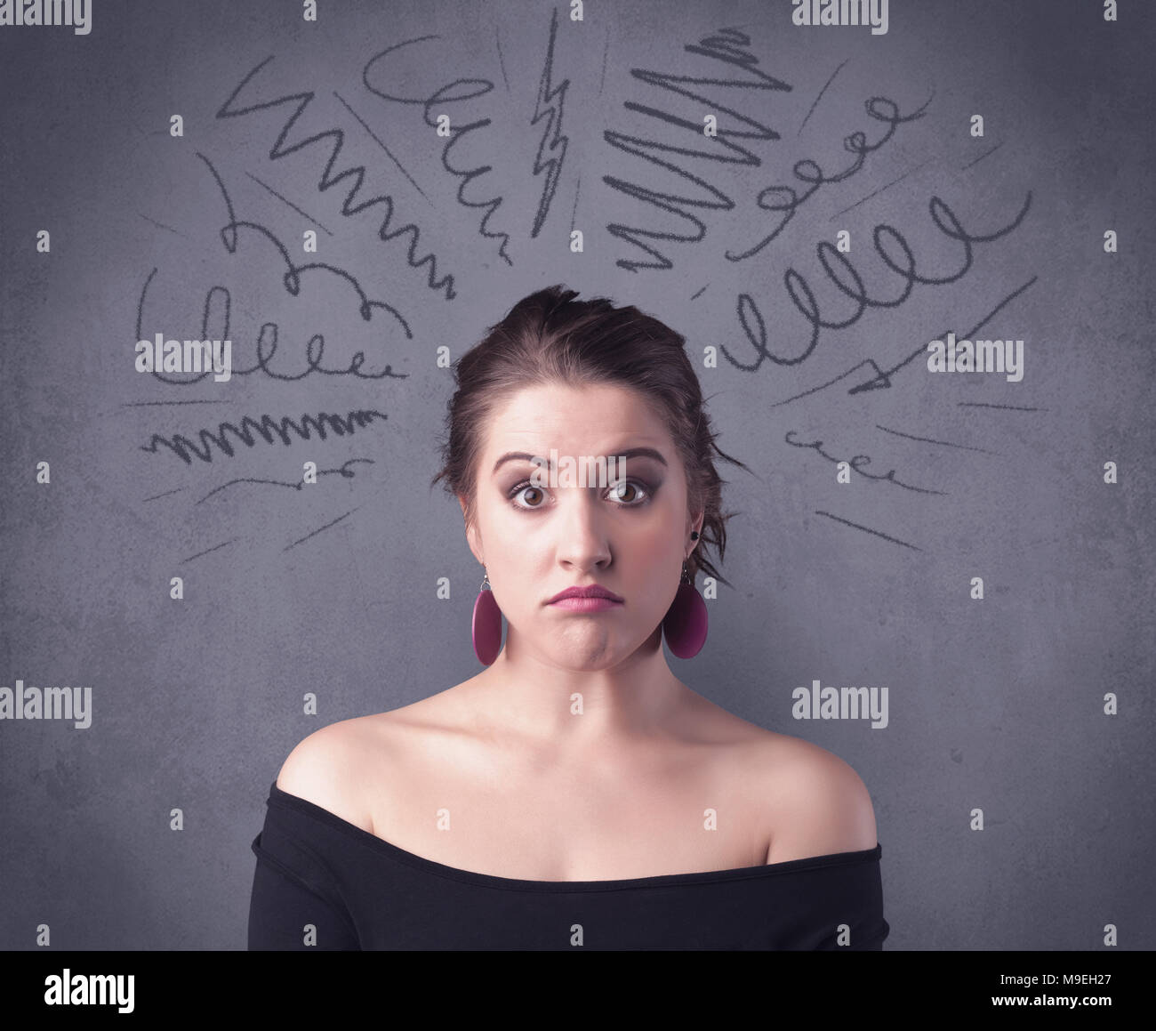 A cute female student making funny face expressions with pressure and ...