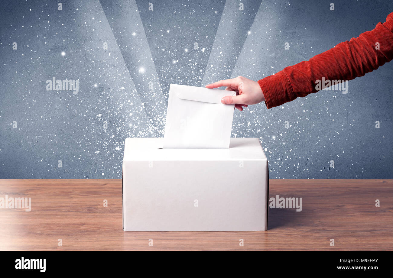 Ballot box with person casting vote on sparkling background Stock Photo ...