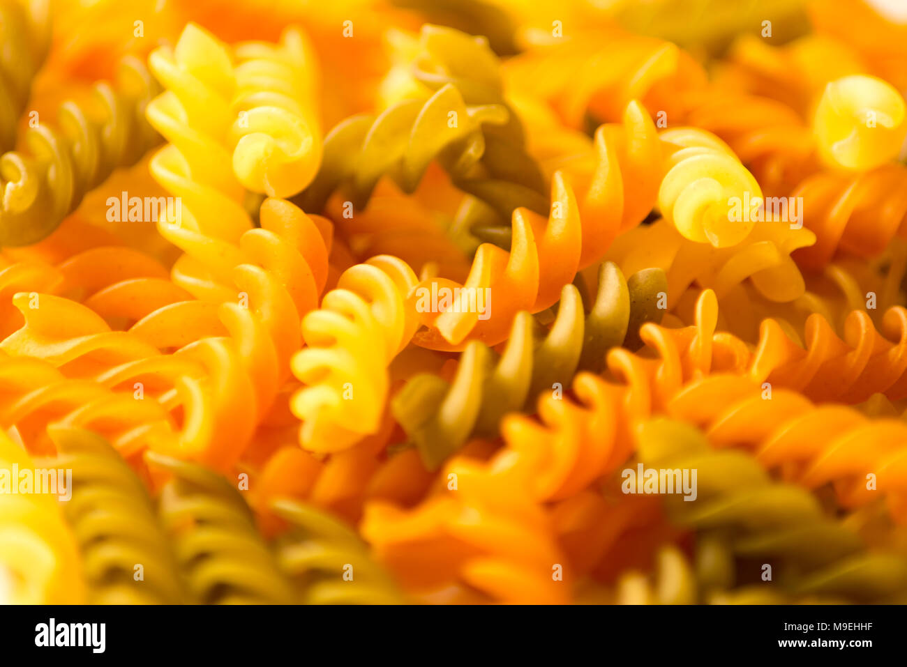 A handful of colored pasta screws Stock Photo - Alamy