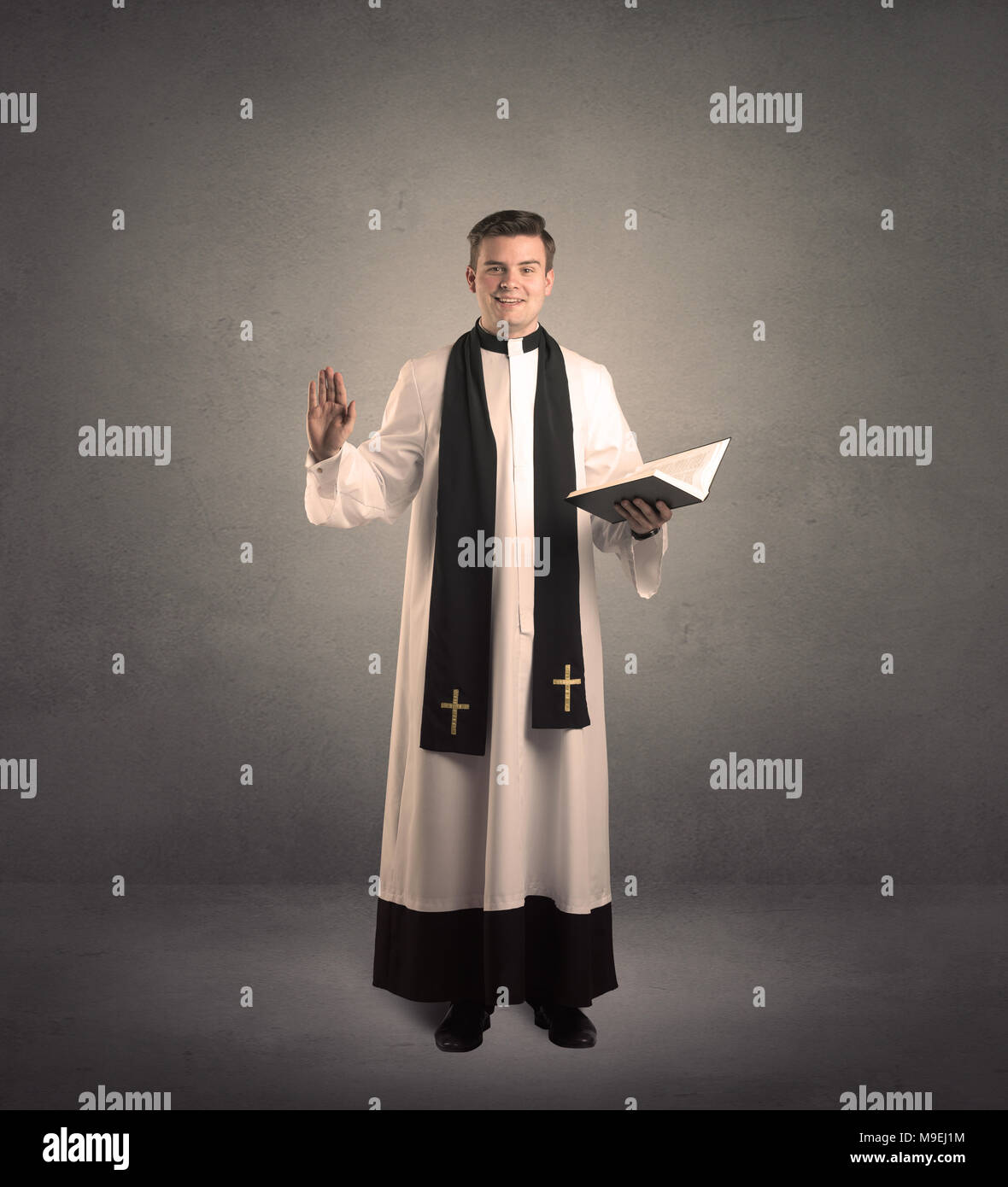 young priest in giving his blessing Stock Photo - Alamy