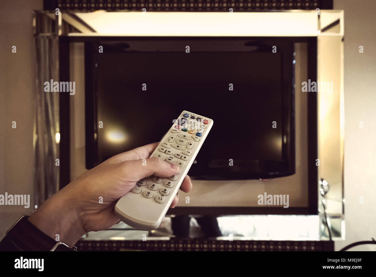 Mans hand television remote control hi-res stock photography and images ...