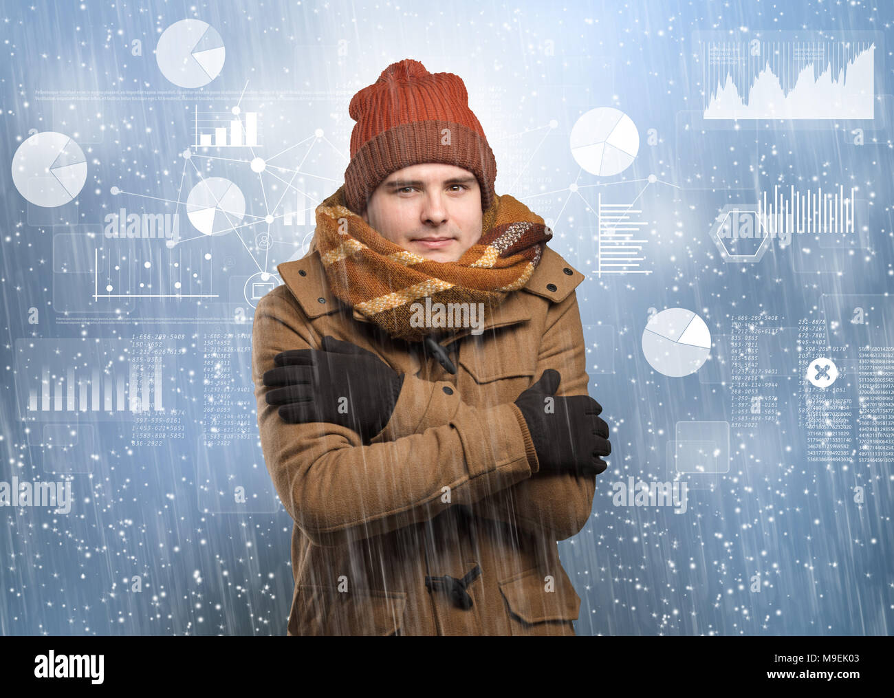 Young businessman shivering with graphs, reports and chart concept ...