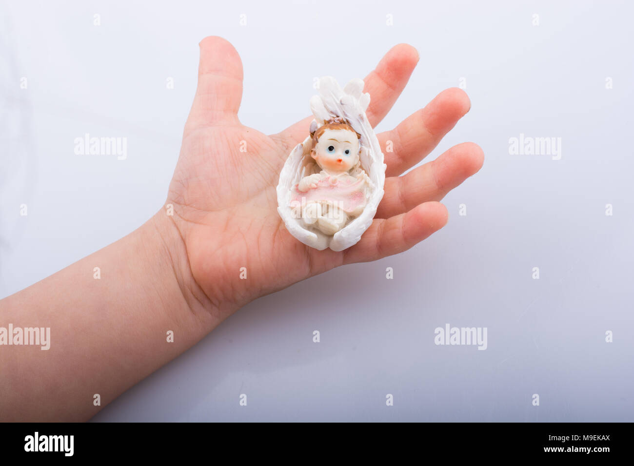 Little baby figure in hand on a white background Stock Photo - Alamy