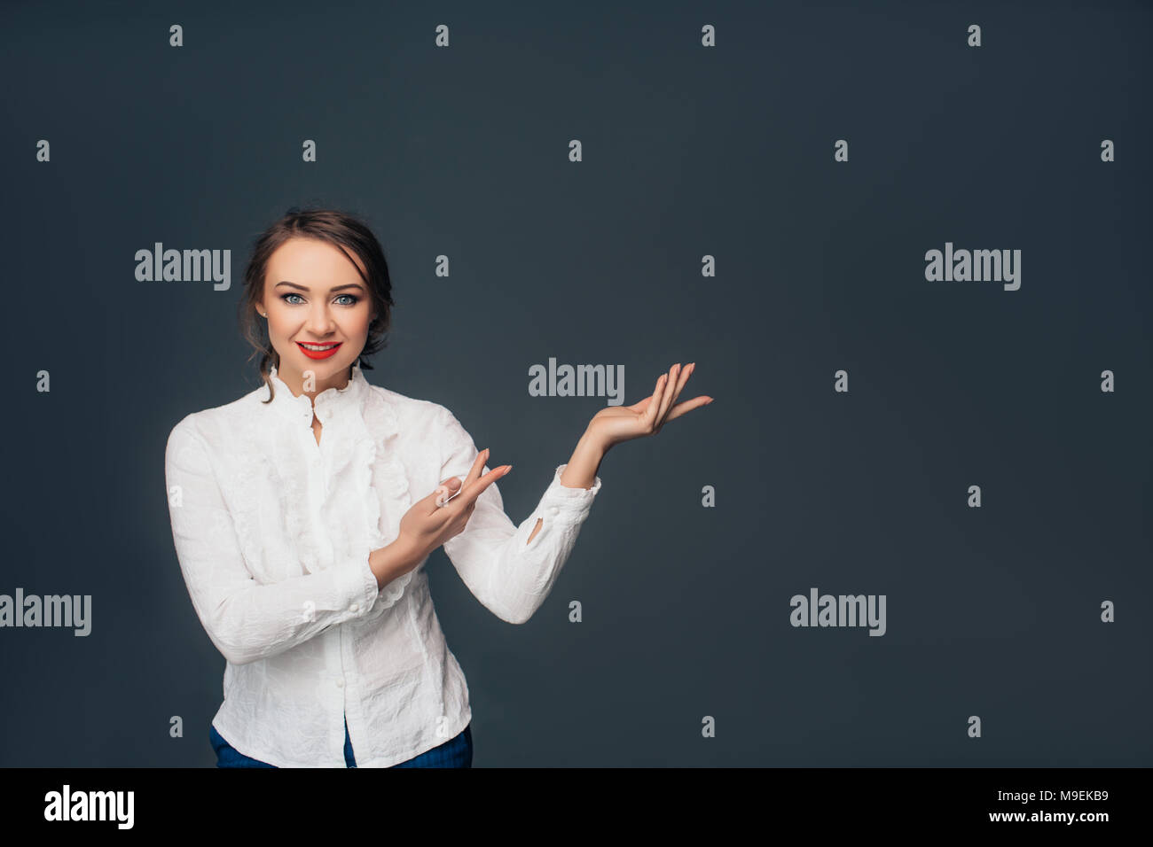 business woman pointing copy space and smiling Stock Photo - Alamy