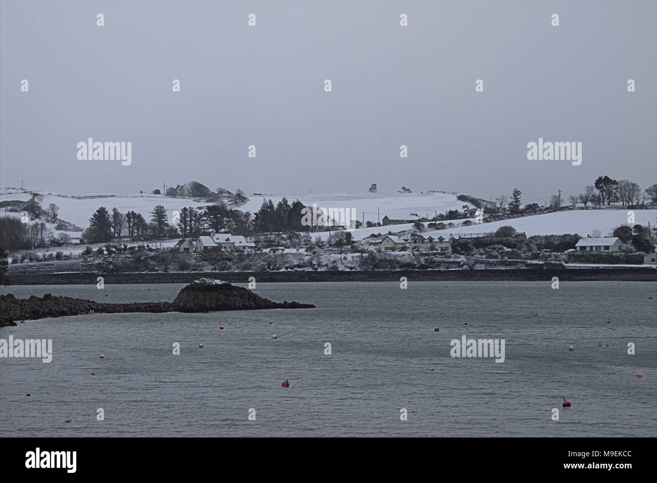 view across castlehaven harbour after winter snow storm Stock Photo - Alamy